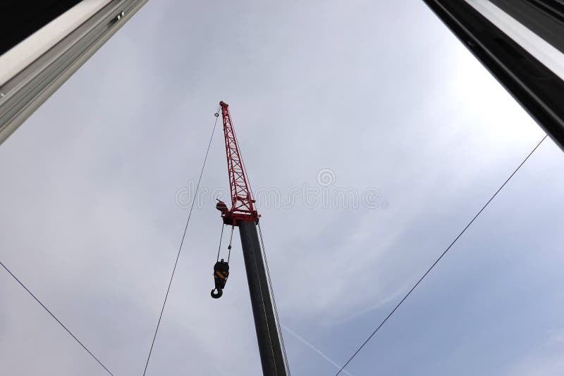 Big Heavy Hook with Yellow Stripes on Metal Cable on Construction Arm ...