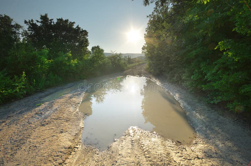Big dirt pool on road. stock image. Image of environment - 99135113