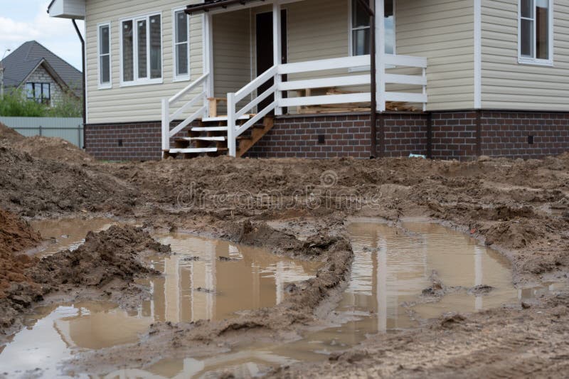 Big Dirt Puddle in Front of New Wooden House Stock Photo - Image of ...