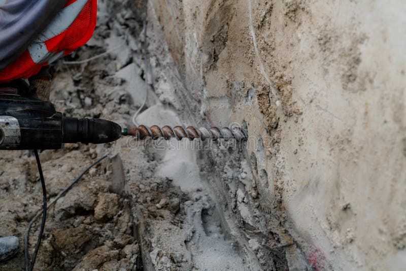 The Big Drill is Spinning at High Speed. To Find a Hole in the Concrete ...