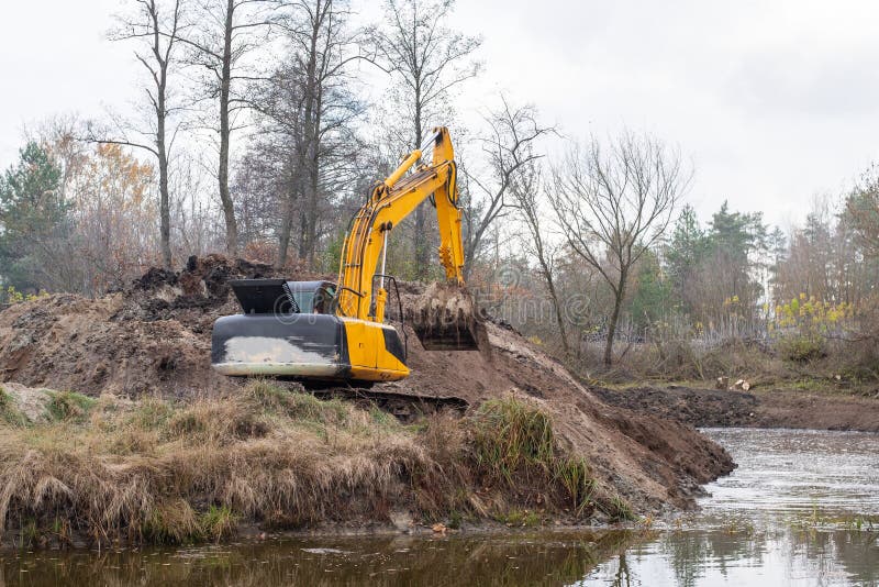Excavator during digging stock photo. Image of drainage - 273422794