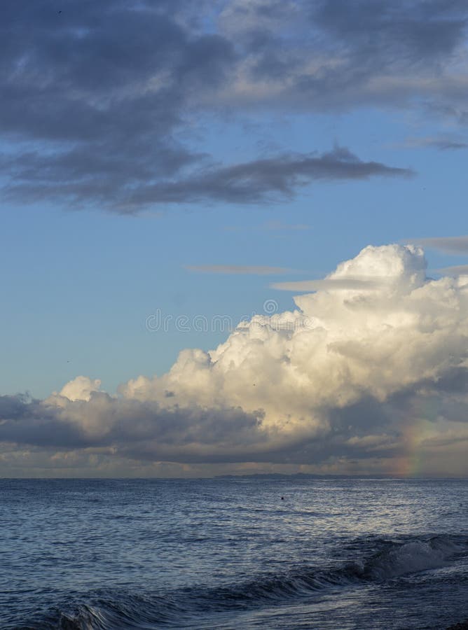 A Big Fluffy Cloud Over the Sea, Rainbow Stock Image - Image of cloud ...