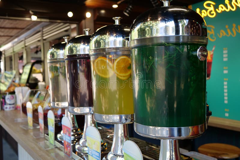 Big Glass Bottles with Fruit Drinks in Bar Stock Image - Image of ...