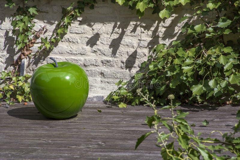 Big Green Artificial Apple on the Wooden Stand Stock Image - Image of ...