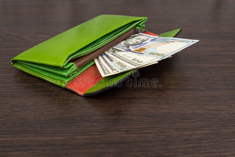 Big Green Wallet with Money on a Brown Background. the Wallet in Which ...