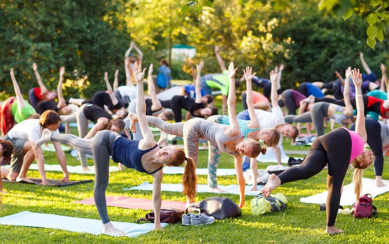 Big Group of Adults Attending a Yoga Class Outside in Park Stock Image ...