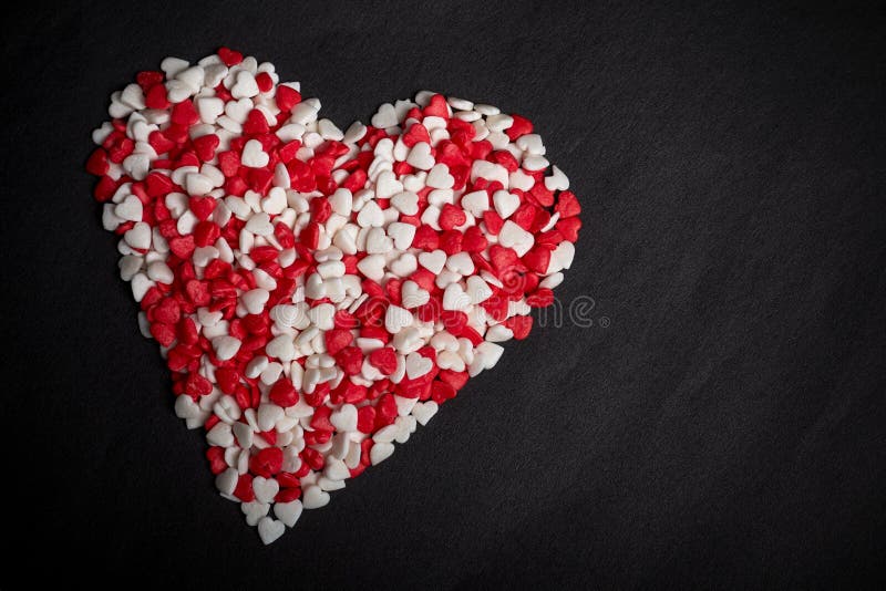 Big Heart from Many Heart-shaped Candies on Black Backdrop Stock Photo ...