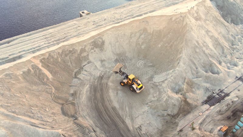 Big Heavy Wheel Loader Loading Sand into Dump Truck in Sand Pit. Heavy ...