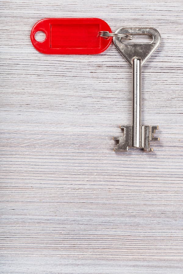 Big Key with Red Key Chain on Wooden Surface Stock Image - Image of ...