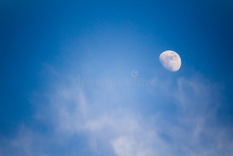 A Big Moon in the Afternoon Against a Blue Sky with Clouds Stock Photo ...