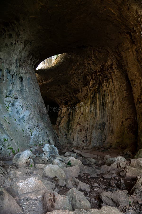 Big Natural Bridge in Stone Cave Illuminating Rocks on the Ground Stock ...
