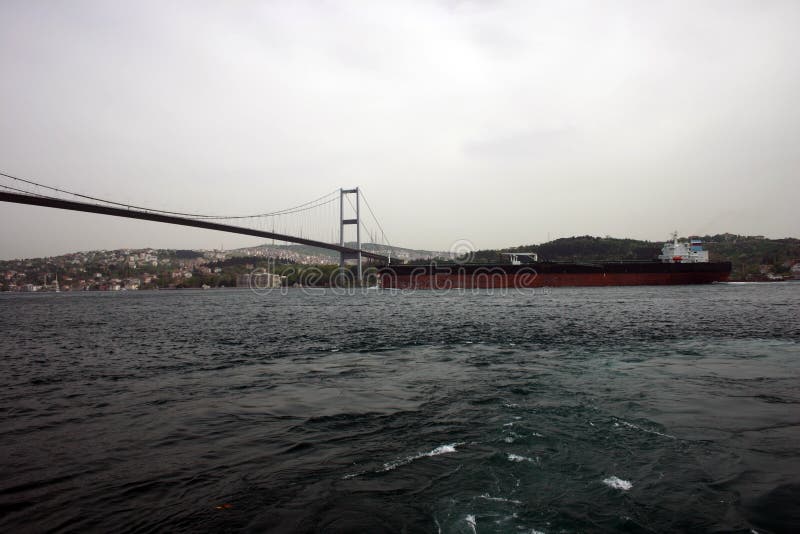 A Big Oil Tanker Passing Under the Bridge in the Bosphorus Stock Photo ...