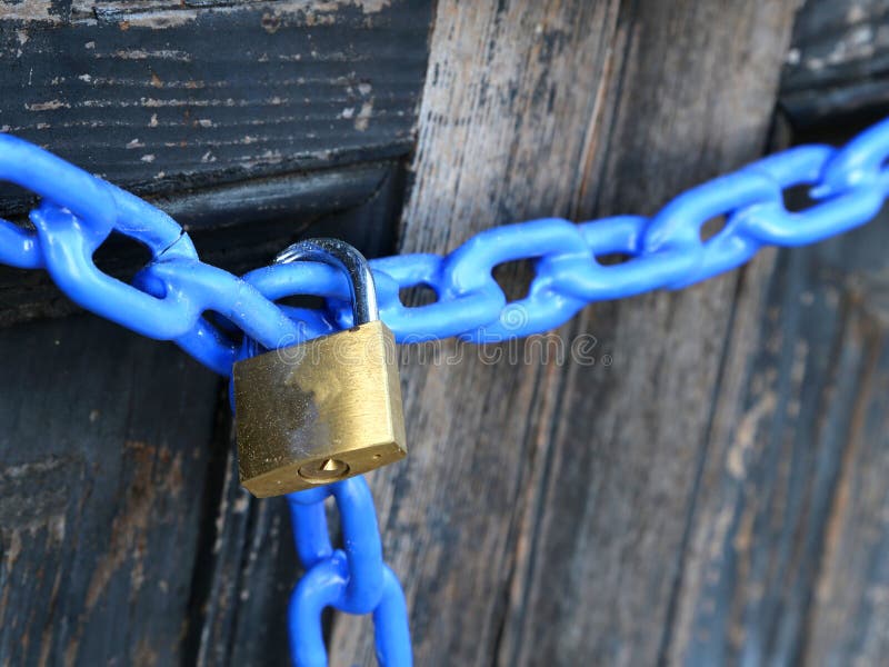 Big Padlock with a Blue Chain and the Door Closed Stock Photo - Image ...