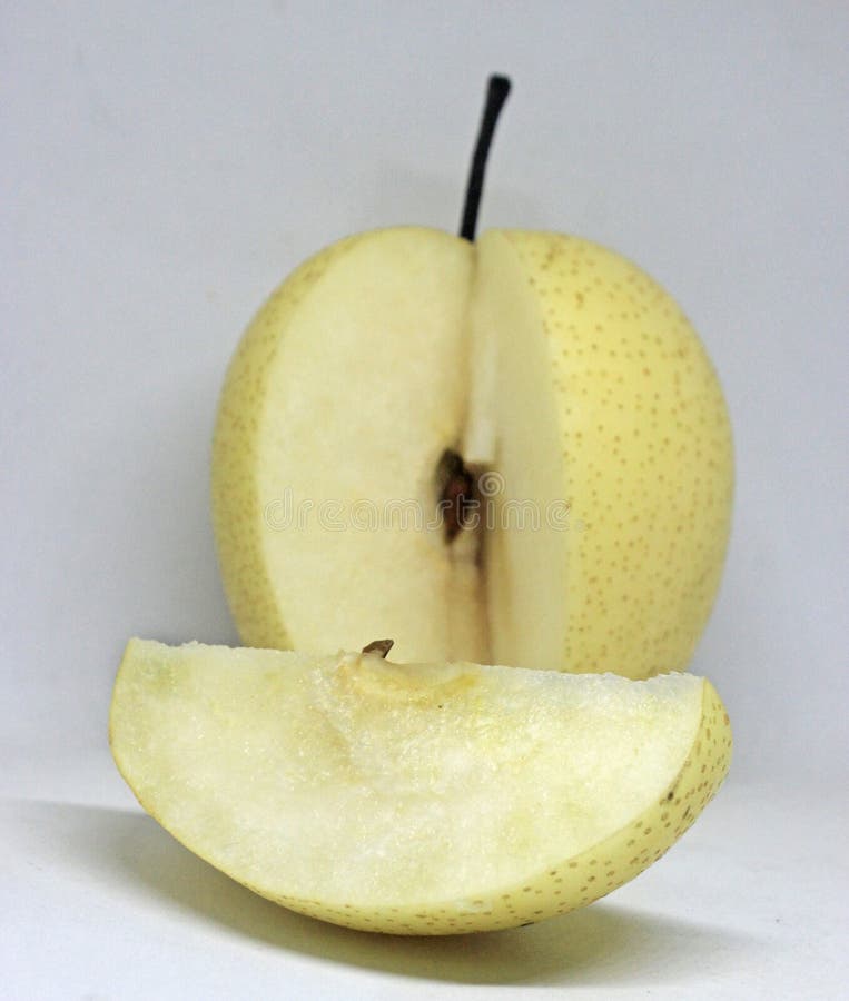 A big pear with its pieces stock image. Image of pears - 243891231