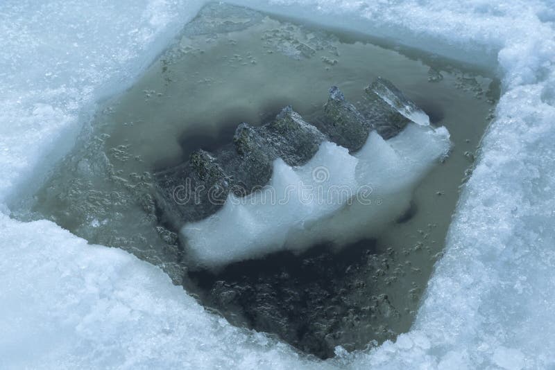 Big Piece of Ice in a Hole Made in a Frozen Mountain Lake Stock Image ...