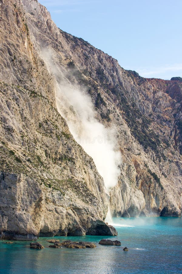 Big Pieces of Rocks Falling into the Sea Stock Photo - Image of smoke ...