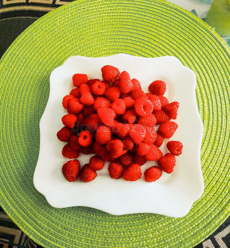 Big Pile of Fresh Raspberries in White Bowl Isolated on Light Green ...