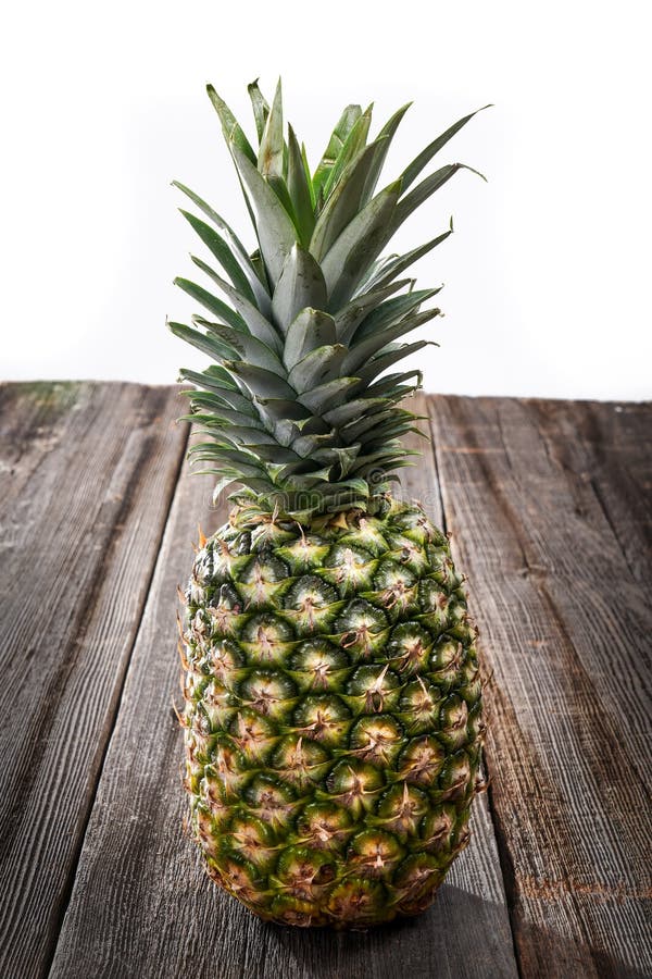 Big Pineapple with Its Leaves on a Barn Wood Board on White Background ...