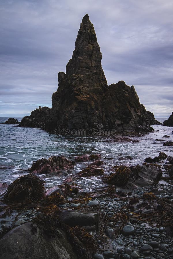 Big Pointed Rock in the Sea after the Waves Stock Photo - Image of ...