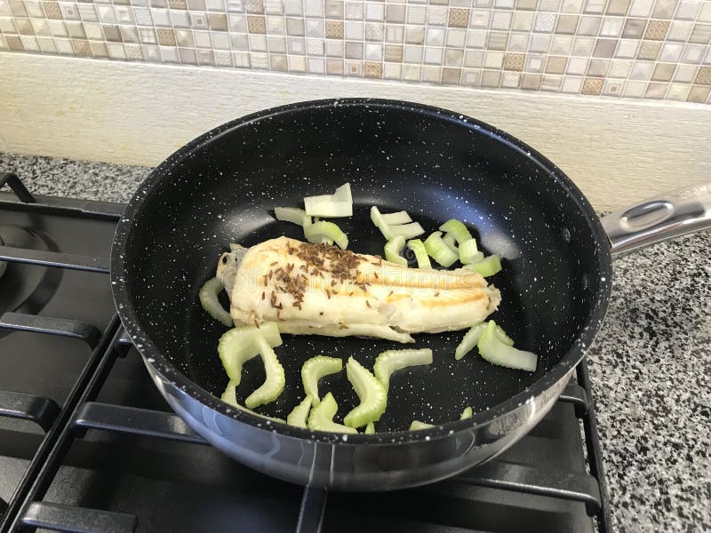 Big Pot with Fish and Celery in Modern Kitchen on a Gas Stove Stock ...