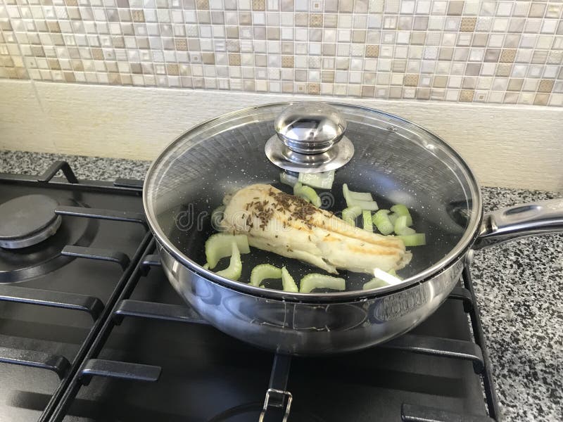 Big Pot with Fish and Celery in Modern Kitchen on a Gas Stove Stock ...