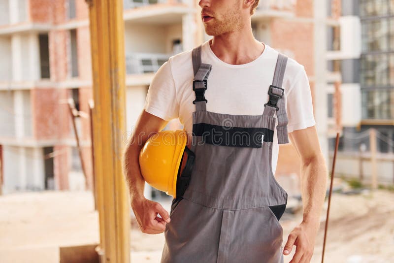 Big Project. Young Man Working in Uniform at Construction at Daytime ...