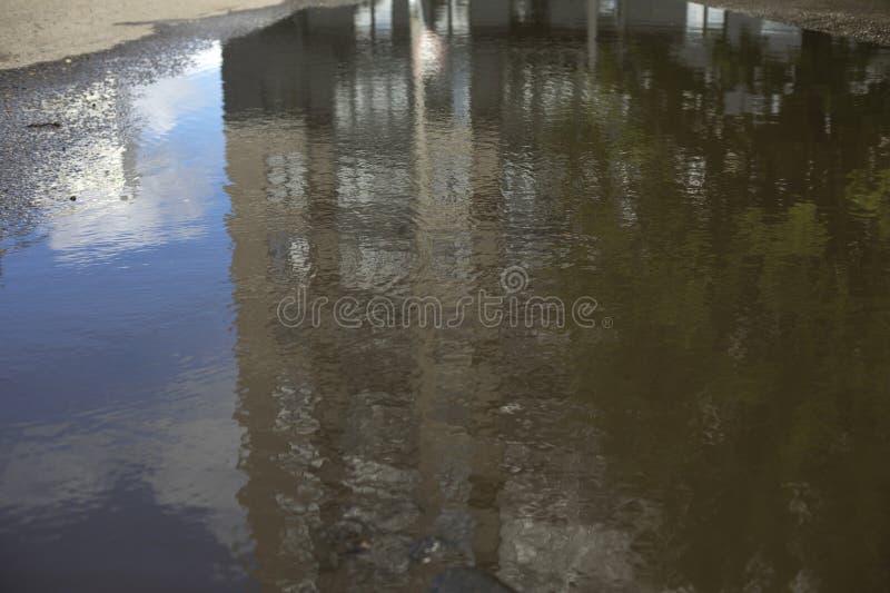Big Puddle in City. Reflection of Building in Puddle Stock Image ...