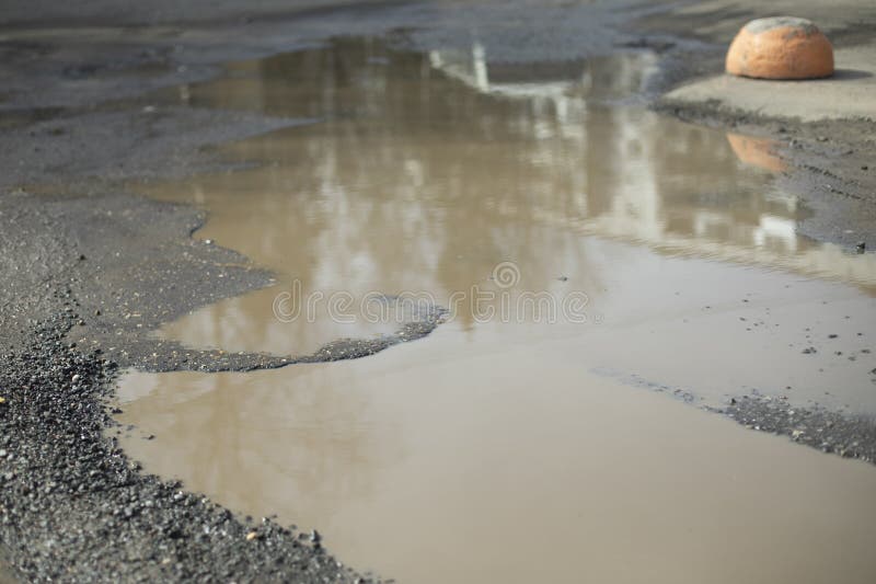 Big Puddle in Road. Puddle and Mud Stock Image - Image of green, blur ...