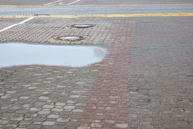 Big Puddle on the Sidewalk in City Stock Image - Image of reflections ...