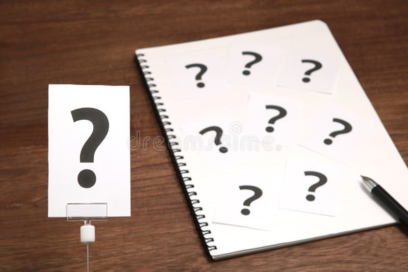 Red Question Mark on a Piece of Paper and Many Question Marks on Cork ...