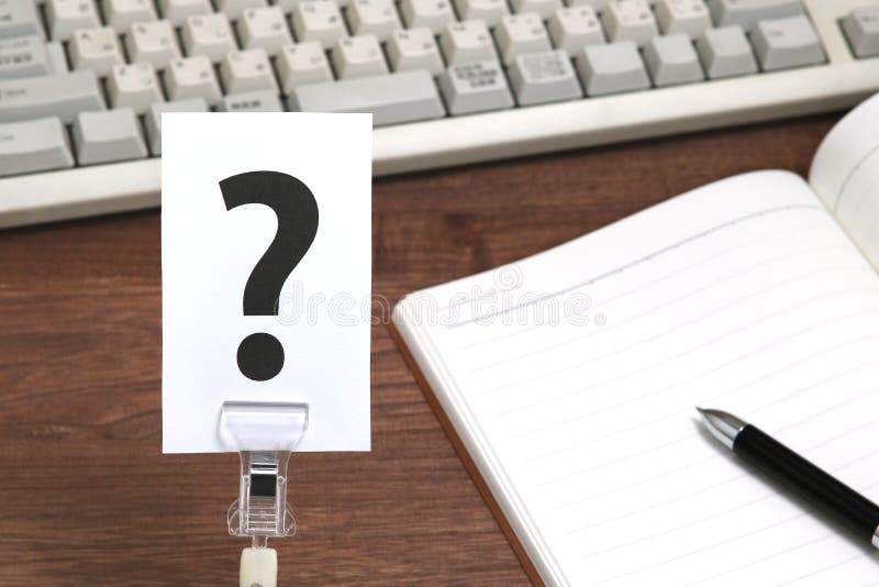 Big Question Mark on a Piece of Paper with Writing Instruments and ...