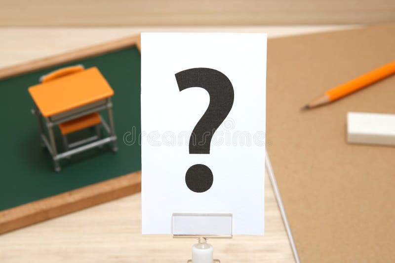 Big Question Mark on White Paper with the Study Tool As the Background ...