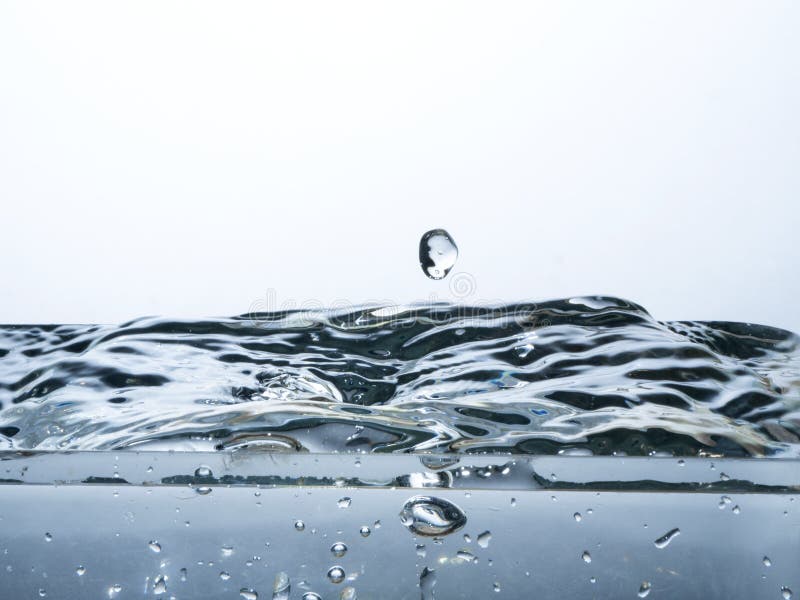 Big Rain Drop Falls on a Wavy Water Surface with a Lot of Splashes ...