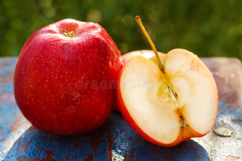 Big Red Apple Lying on the Table Stock Image - Image of drops, outdoor ...