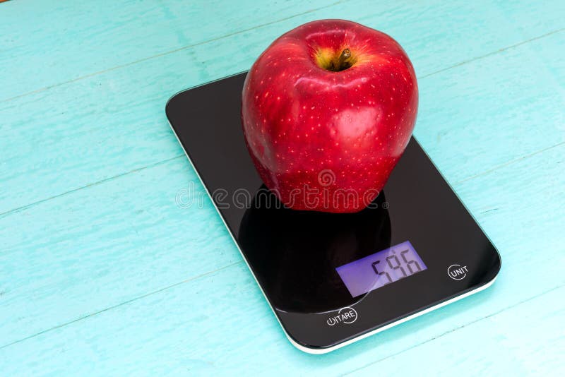 Big Red Apple on the Scales Stock Photo - Image of huge, dieting: 231895270