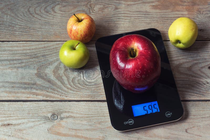 Big Red Apple on the Scales Stock Photo - Image of huge, dieting: 231895270