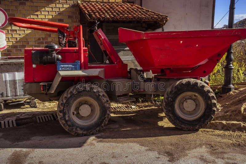 A Big Red Dump Truck in Front of a Building Under Construction. Stock ...