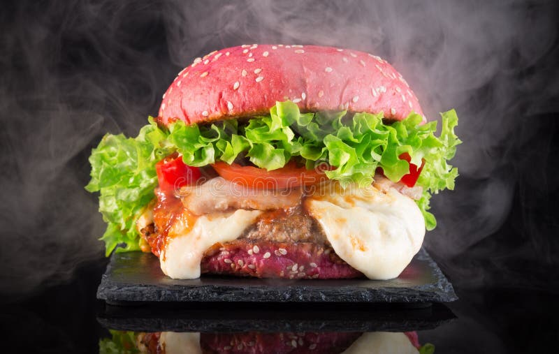 Big Red Hamburger with Smoke on a Slate Table Stock Photo - Image of ...