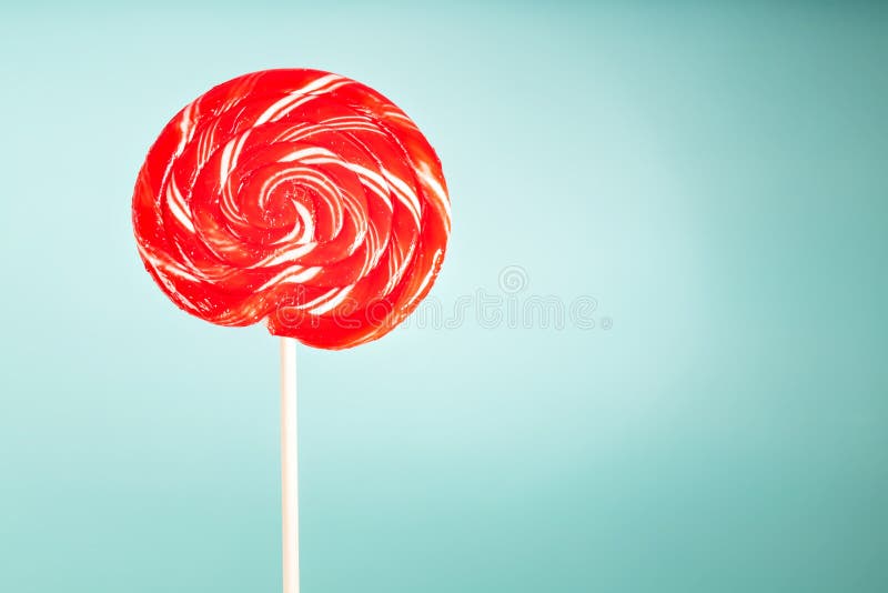 Big Red Lollipop on Blue Background Stock Image - Image of sweet, swirl ...