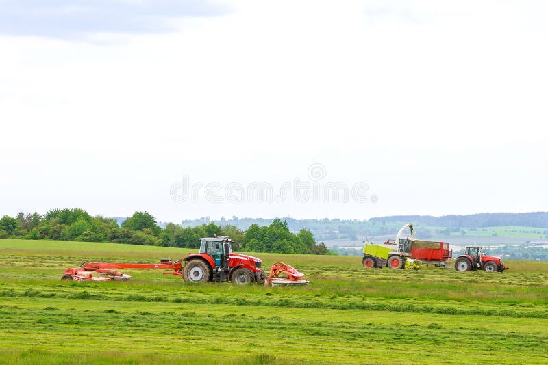 Big Red Tractor with Two Mowers Mows the Grass for Silage Editorial ...