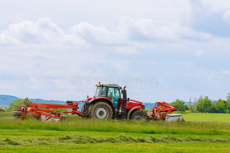 Big Red Tractor with Two Mowers Mows the Grass for Silage Stock Image ...