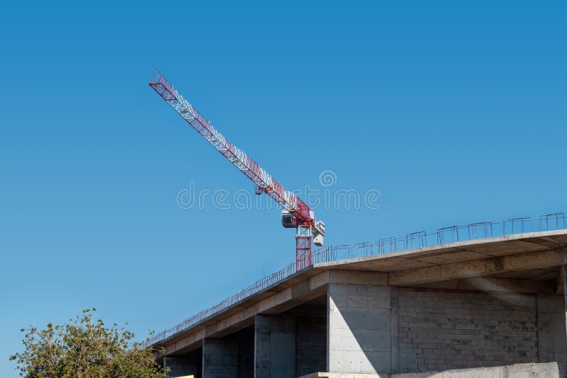Big Red and White Construction Crane in Front of Cloudless Sunny Blue ...
