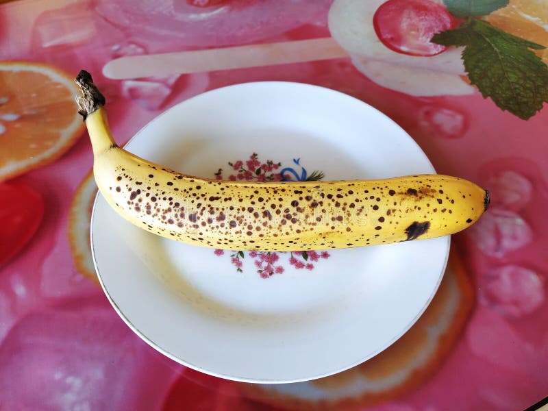 Big ripe banana on a plate stock photo. Image of freshness - 219698458
