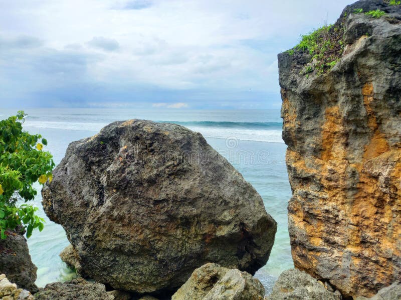 Big rock on the beach stock photo. Image of colorful - 261663124