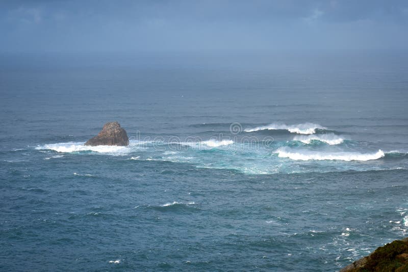 Big Rock in the Middle of the Ocean with Waves Stock Image - Image of ...