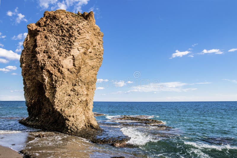 Big rock observing the sea stock photo. Image of ocean - 100122798