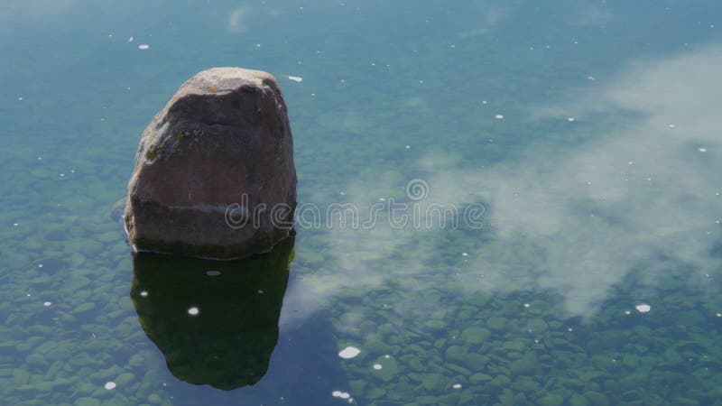 Big Rock Surrounded by Water Surface and Reflecting Clouds in Summer ...