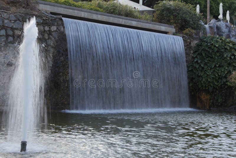Big Rock Waterfall into Tropical Garden Stock Image - Image of travel ...
