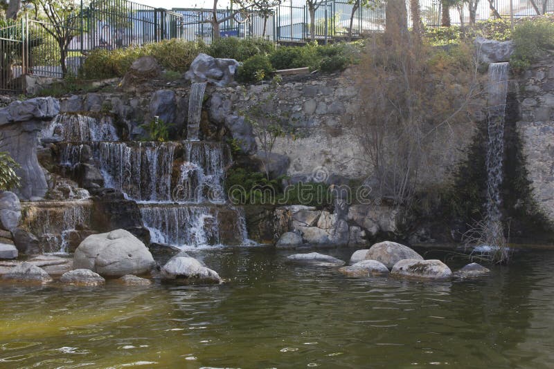 Big Rock Waterfall into Tropical Garden Stock Photo - Image of ...