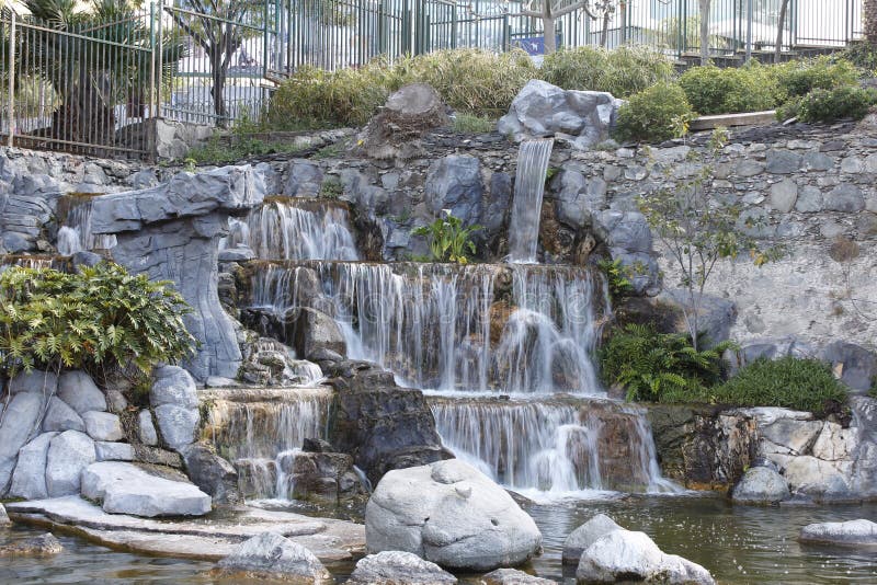 Big Rock Waterfall into Tropical Garden Stock Image - Image of majestic ...